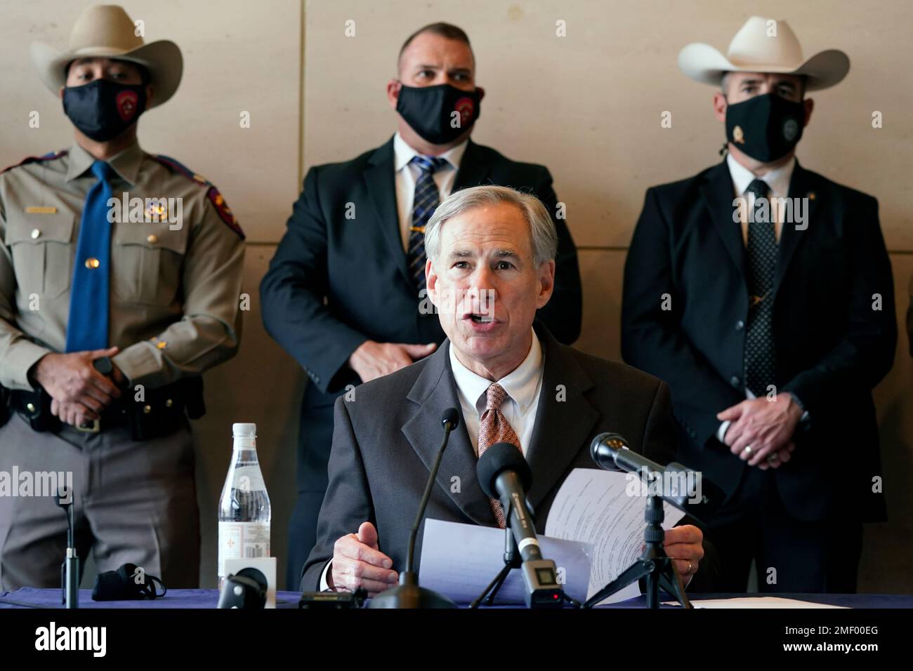 A masked Texas Gov Greg Abbott speaks at a news conferenced about ...