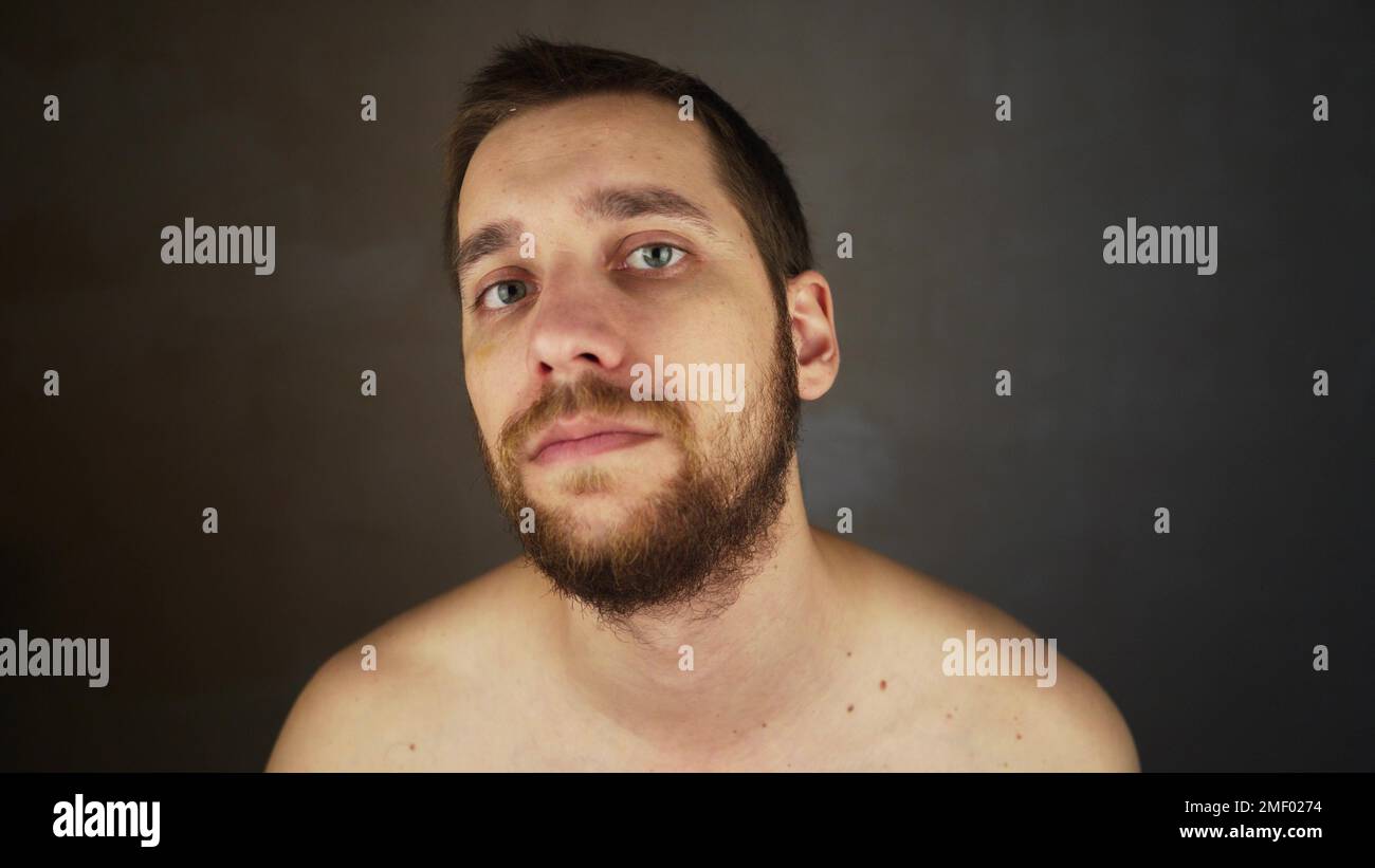 Guy refuses to shave his beard. Close-up portrait of a young handsome ...