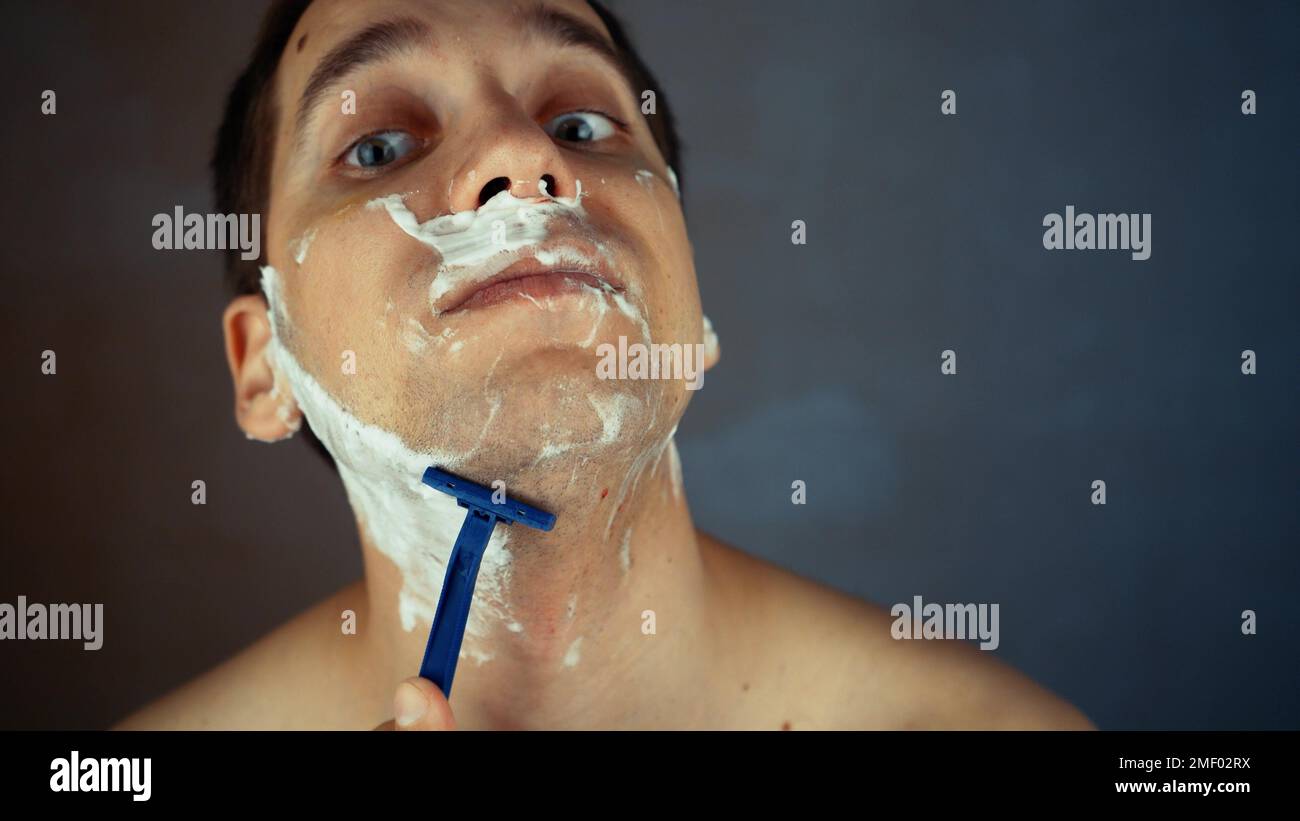 Young man shaving using disposable hi-res stock photography and images ...