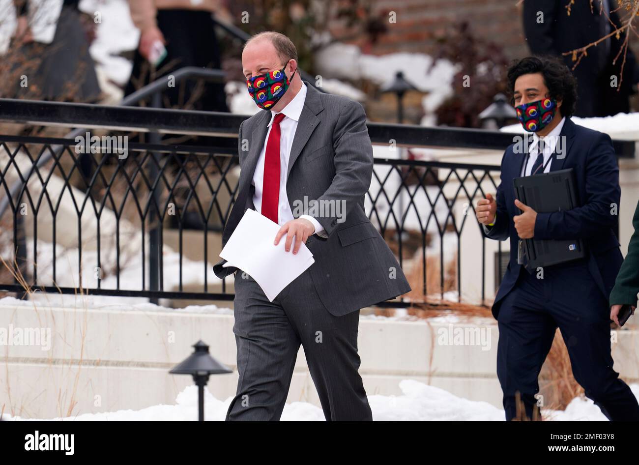 Colorado Gov. Jared Polis, left, is followed by special assistant Sam ...