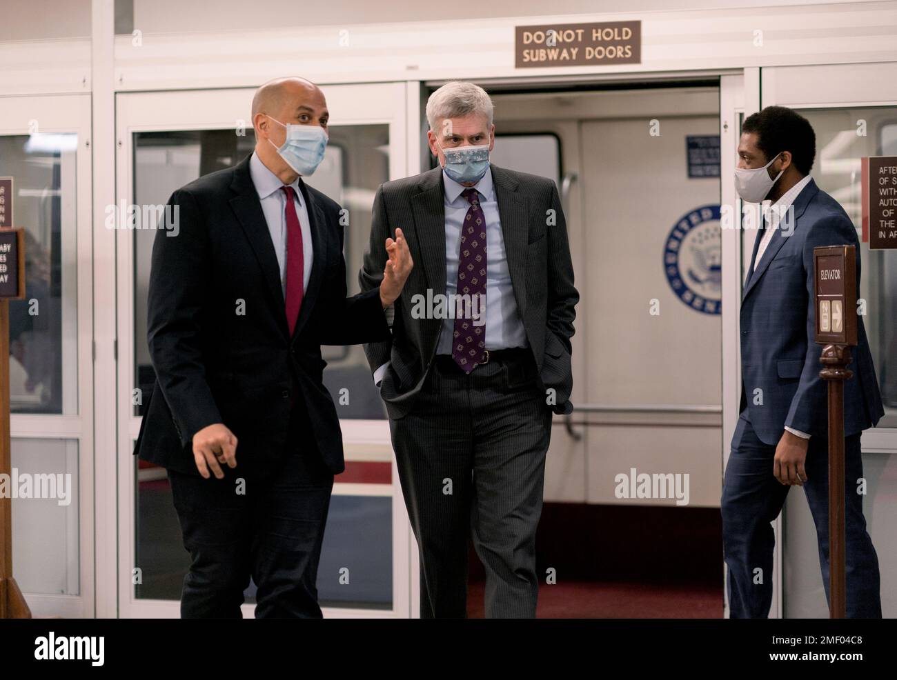 Sen. Cory Booker, D-N.J., left, talks with Sen. Bill Cassidy, R-La., as ...