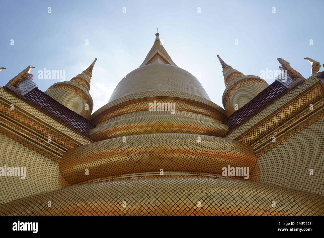 A low angle view of The Golden Palace of Kings in Bangkok under blue ...