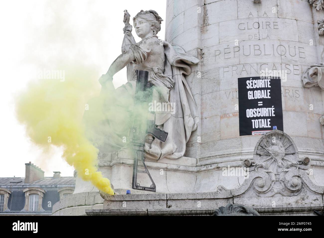 A placard depicting a flash ball gun (LBD) is on display during an ...
