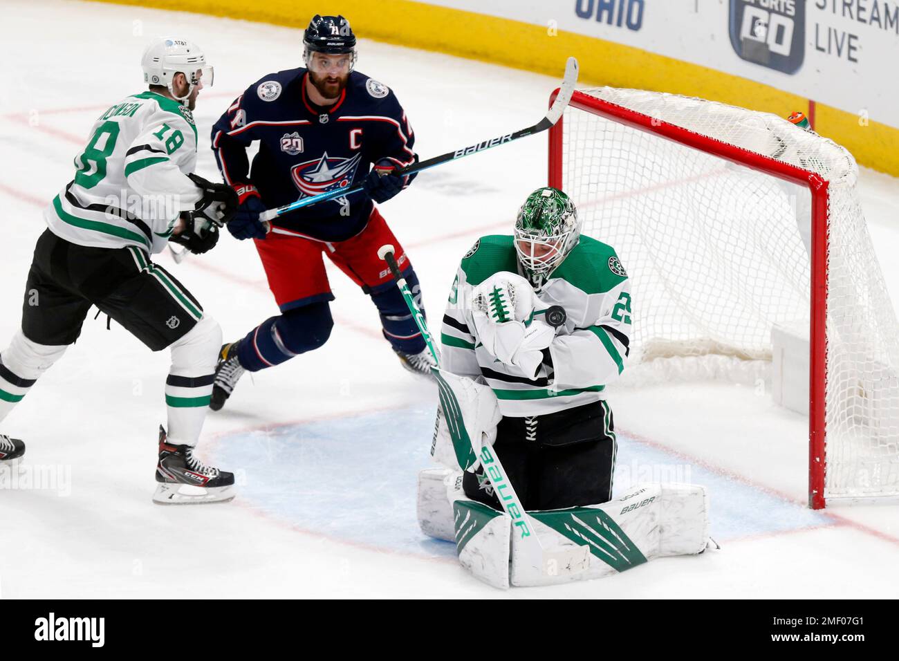 Dallas Stars goalie Jake Oettinger, right, makes a stop in front of ...