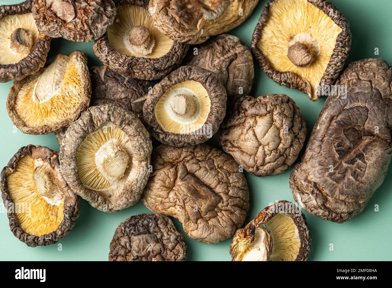 a Bunch of dried shiitake mushrooms against green background Stock ...