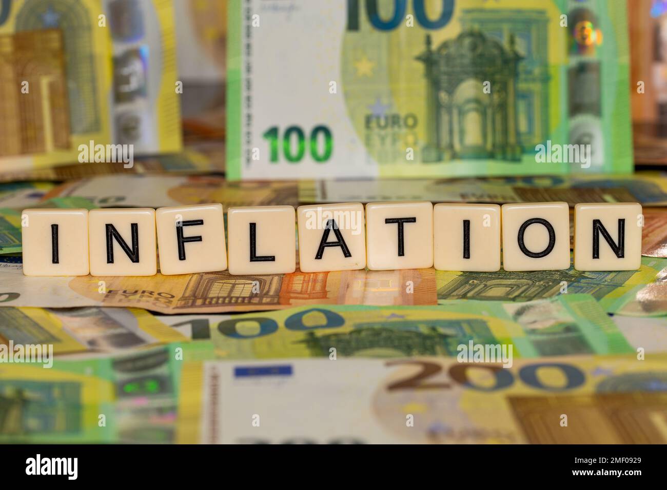 Symbol image of inflation: Euro banknotes and letter cubes showing the ...