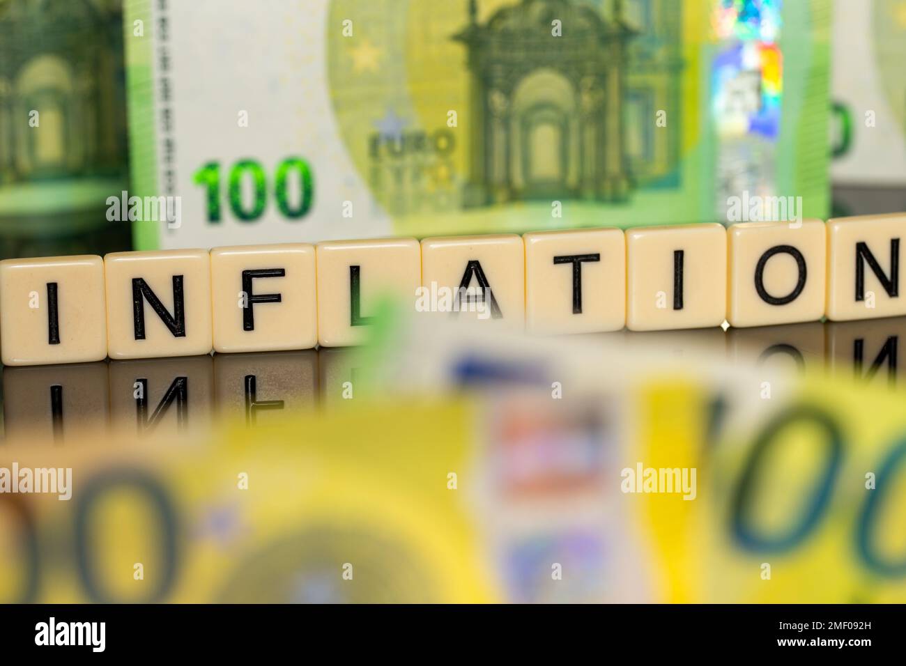 Symbol image of inflation: Euro banknotes and letter cubes showing the ...