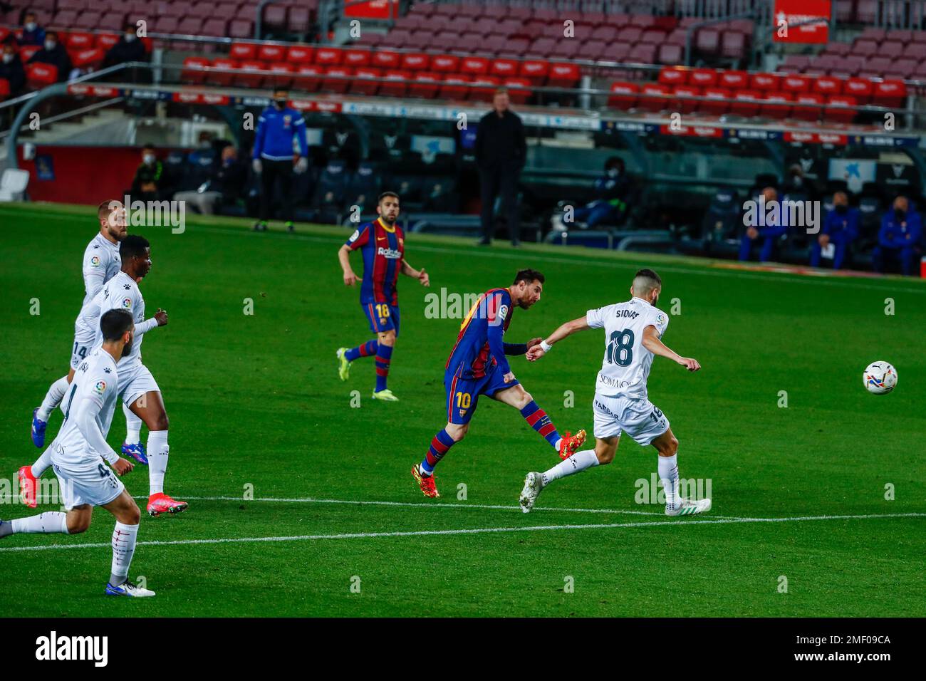 Barcelona's Lionel Messi, center, kicks the ball as he score the ...