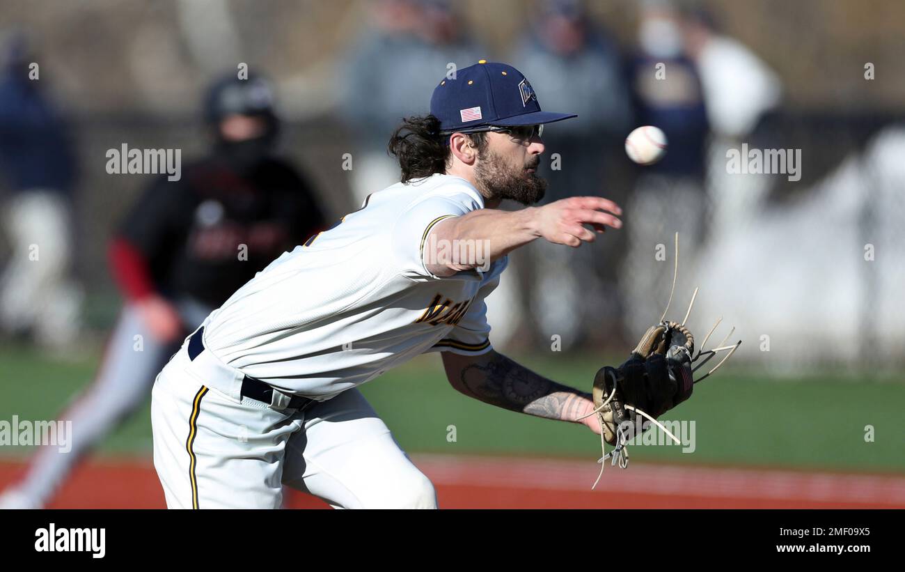 Merrimack College pitcher LT Pare(4) throws during an NCAA baseball ...