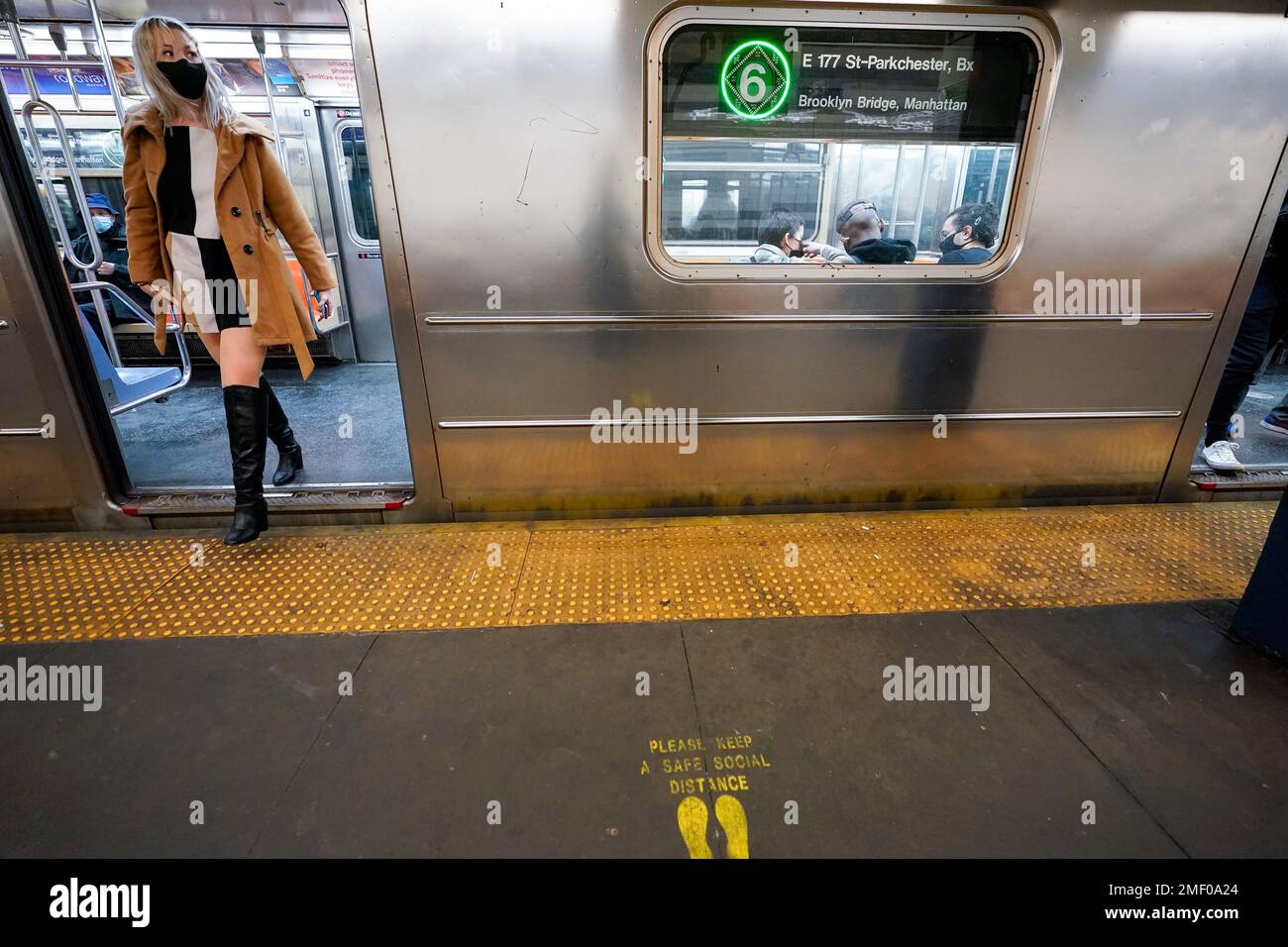 A proper social-distancing marker is painted on the platform as a ...