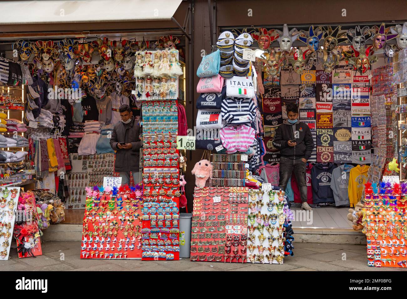 Men on mobile phone inside souvenir shop, Venice, Italy Stock Photo - Alamy