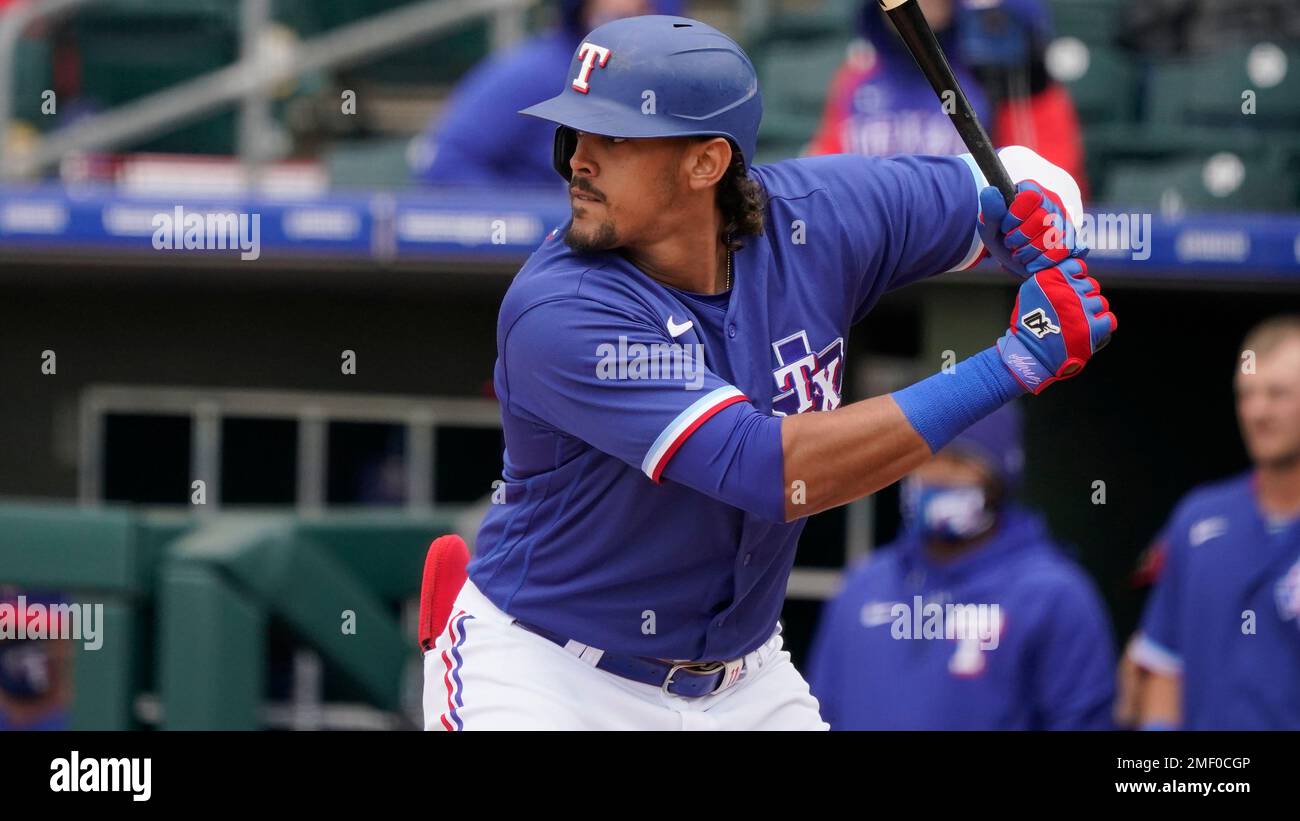 Texas Rangers' Ronald Guzman bats in a spring training baseball game ...