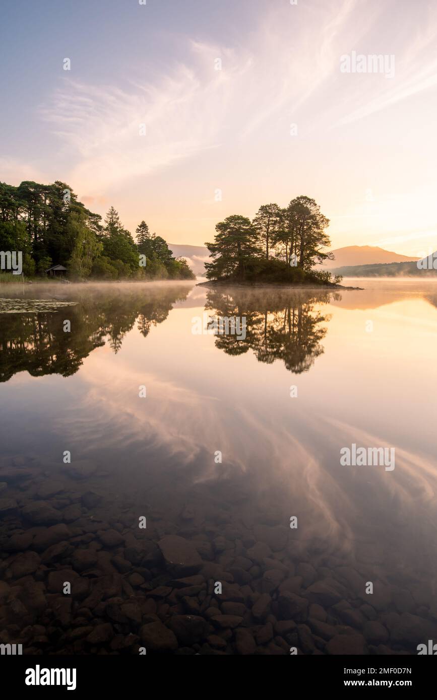 Summer sunrise reflections in Derwentwater, Manesty Island, Keswick ...