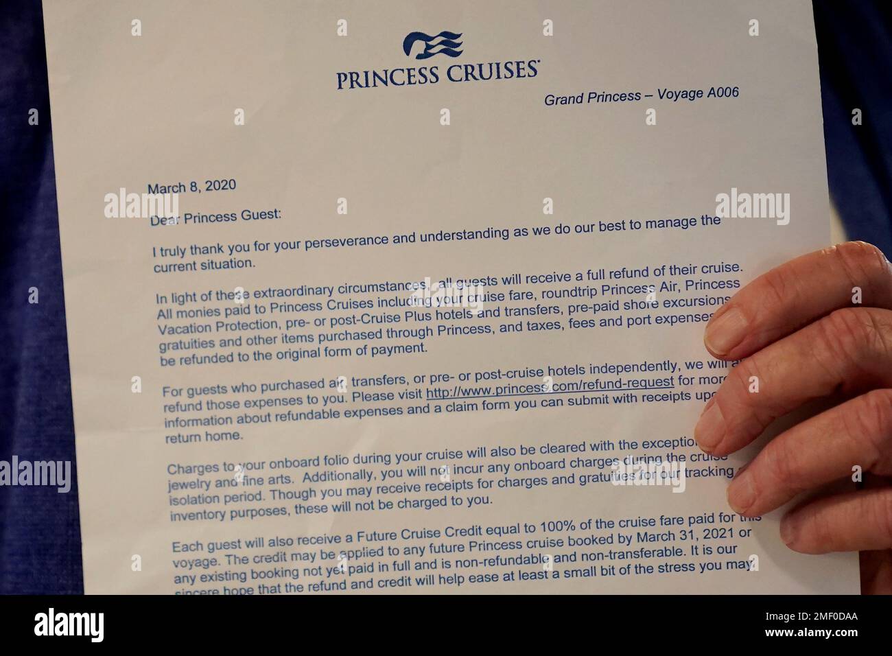 Laurie Miller shows a letter from Princess Cruises while interviewed in ...
