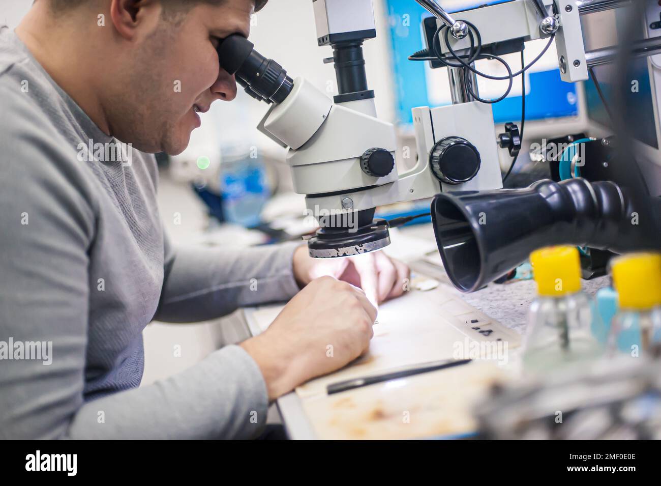 The employees in the workshop do their daily work. A workbench full of ...
