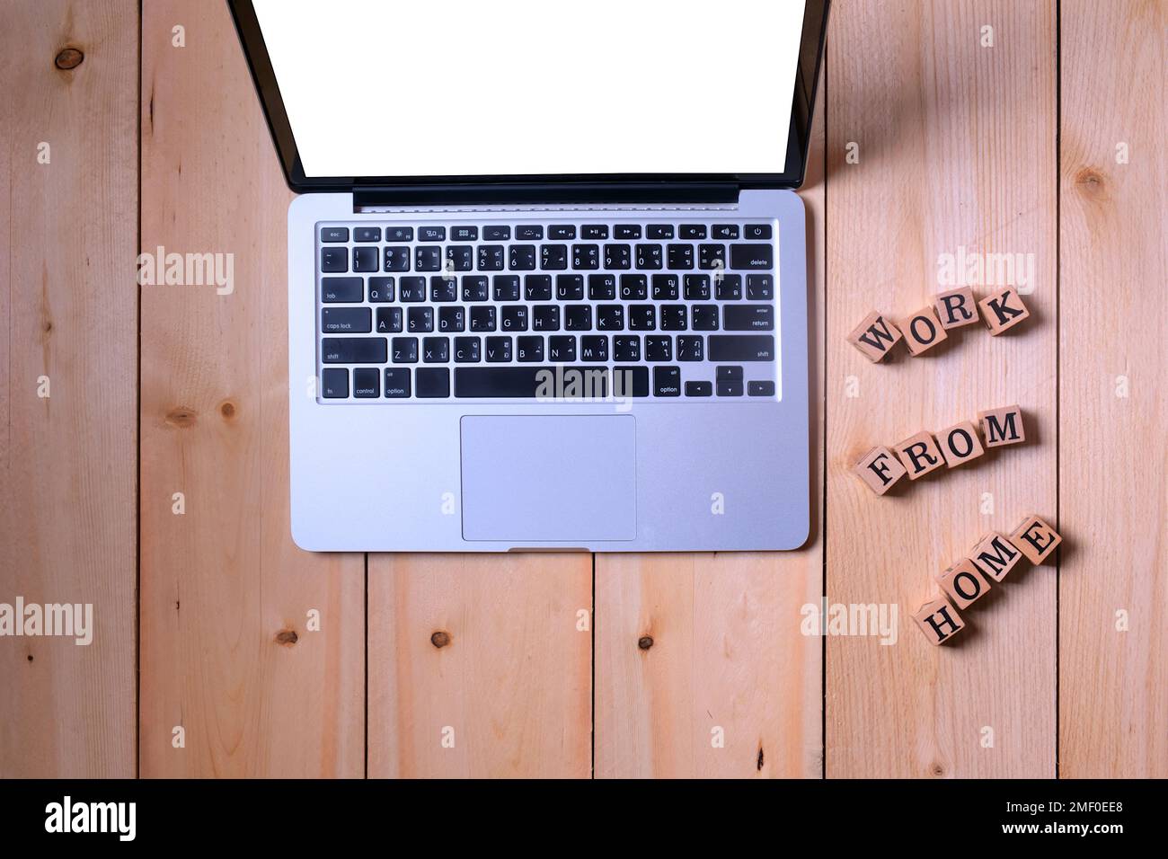 Open computer laptop portable on white blank display and wood cube ...