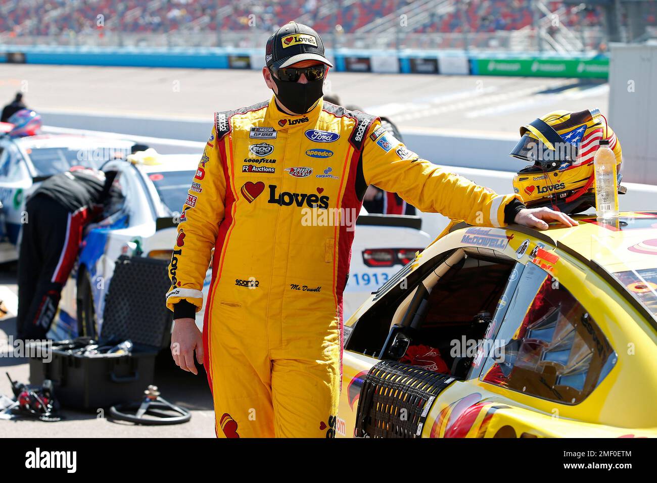 Michael McDowell stands with his race car on pit road prior to a NASCAR ...