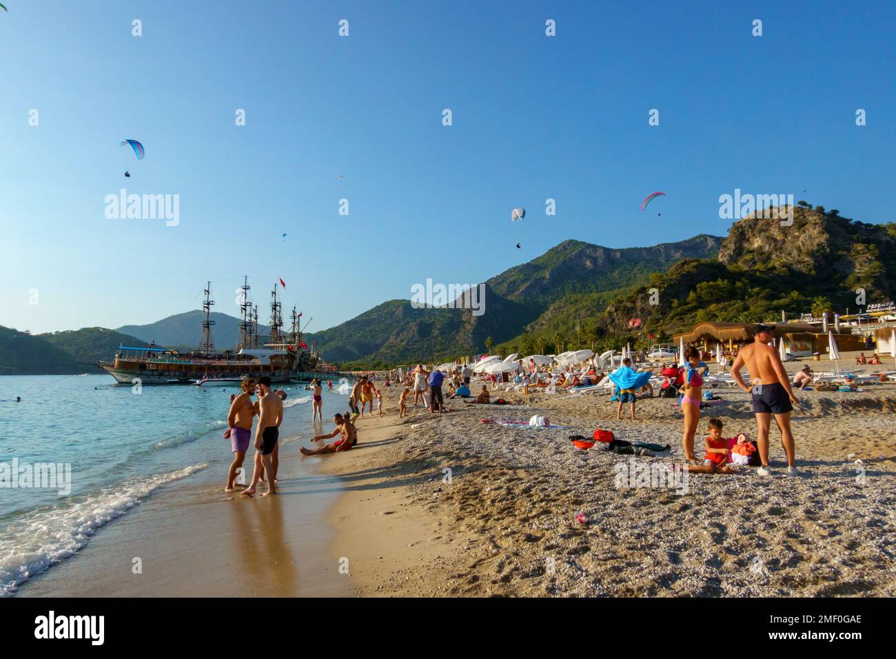 Beachgoers and paragliders in Belcekiz Beach, Oludeniz, Fethiye, Turkey ...