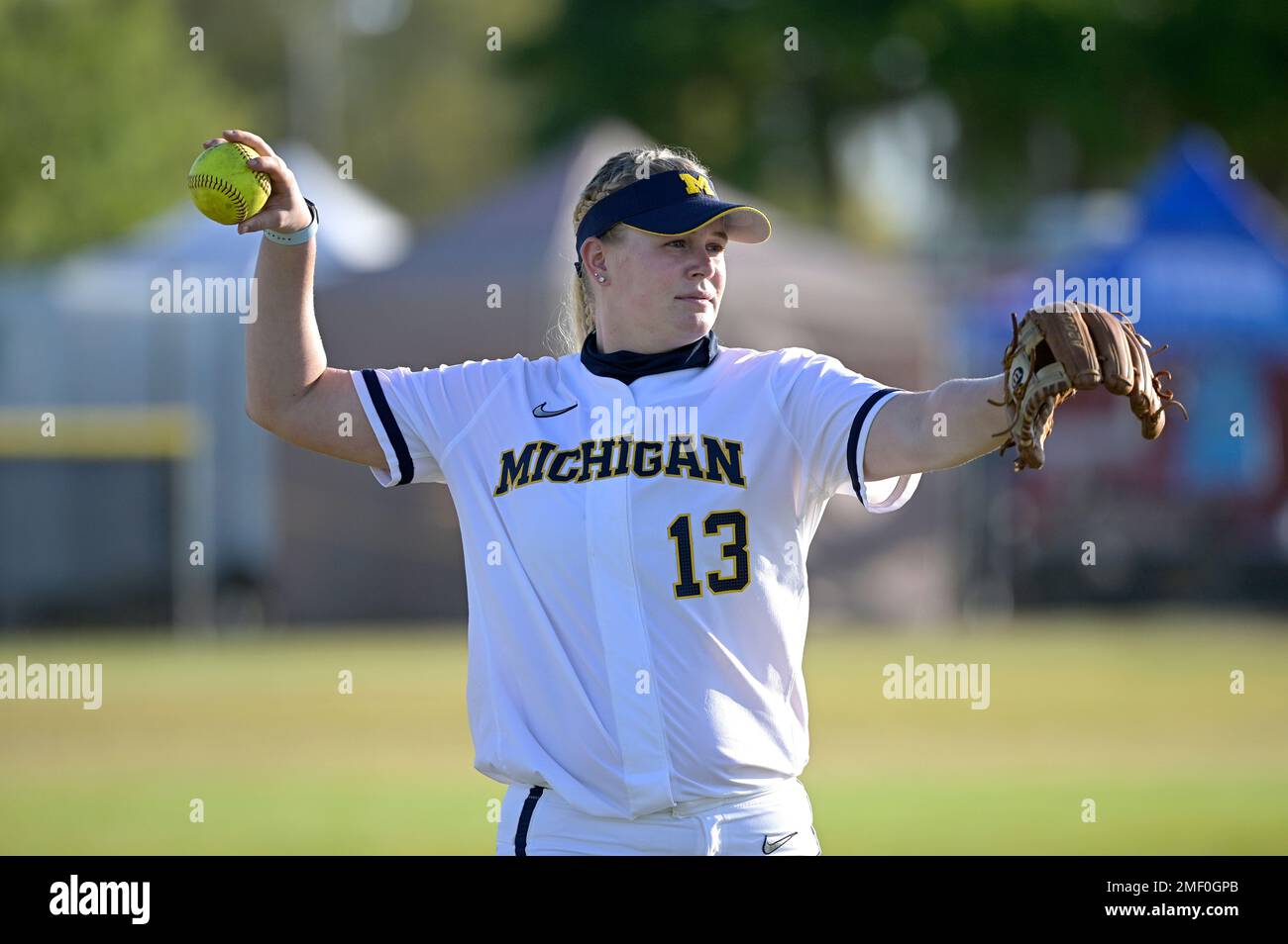 Michigan's Taylor Bump (13) throws before an NCAA college softball game ...