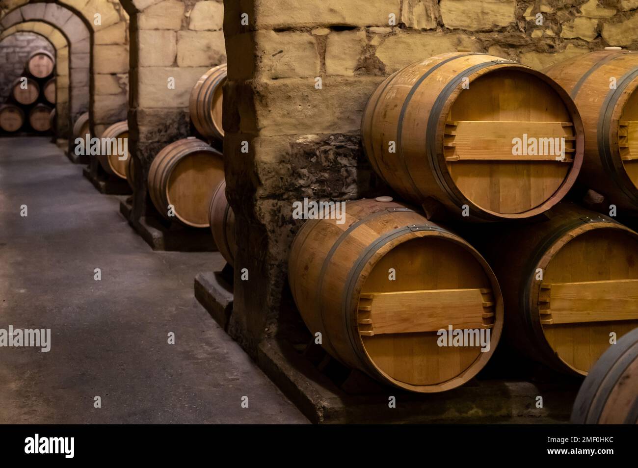 Old french oak wooden barrels in underground cellars for wine aging ...