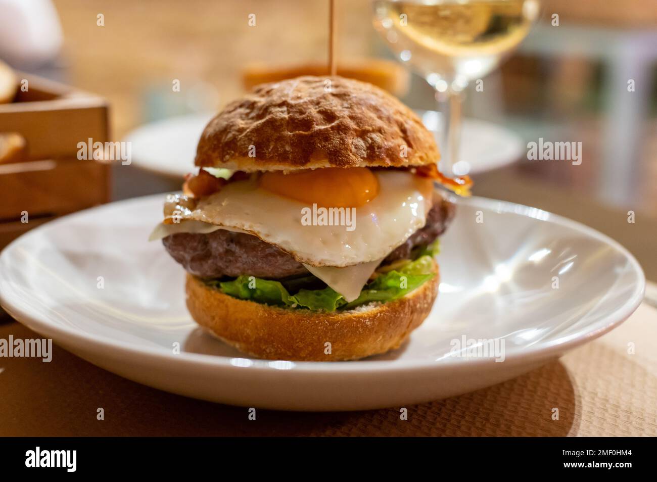 Tasty burger made with white crispy ban, beef burger, egg, green ...