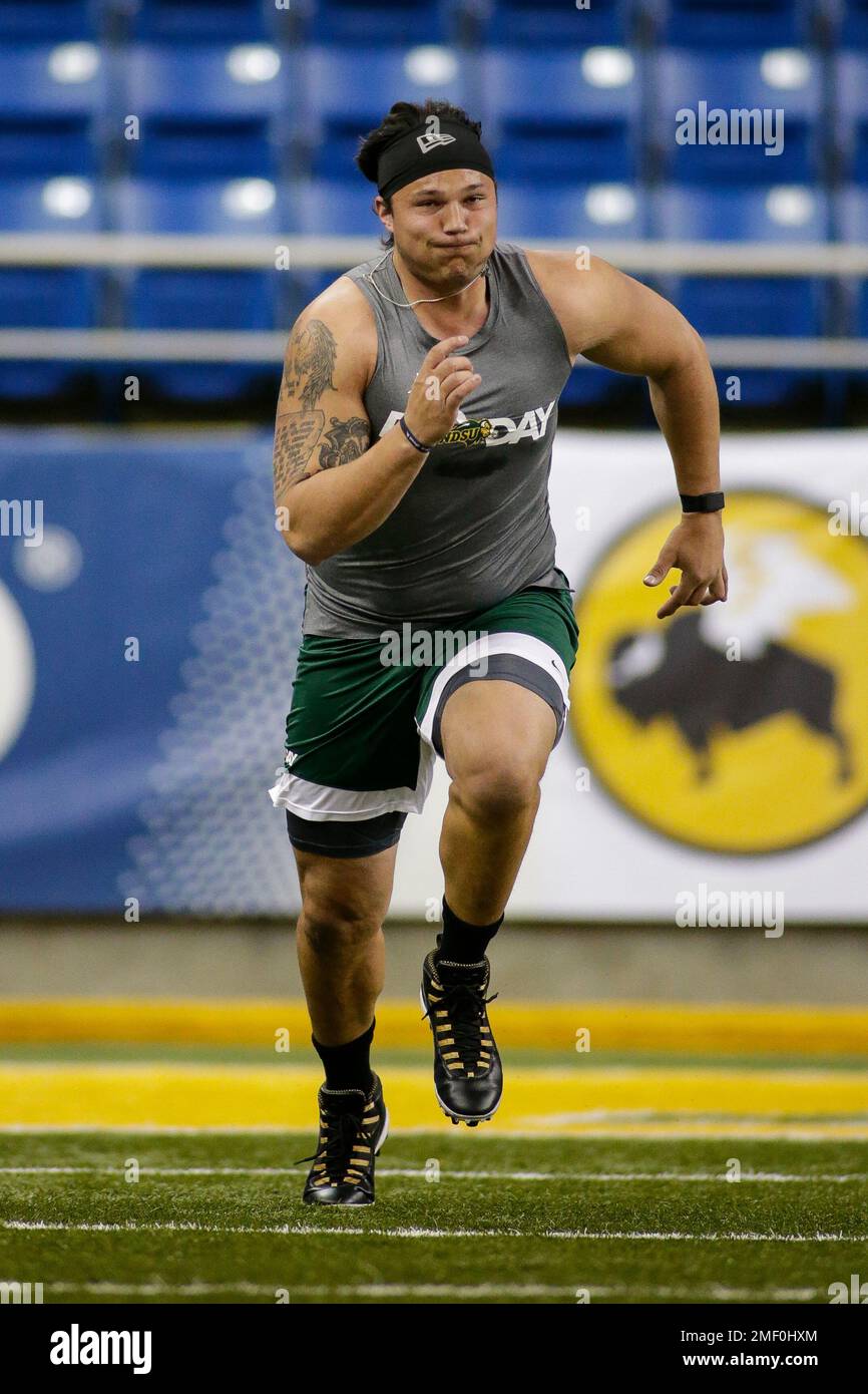 NFL scouts watch North Dakota State lineman Dillon Radunz runs at the ...
