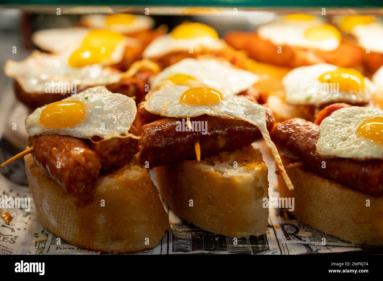 Typical snack of Basque Country, pinchos or pinxtos skewers with small ...