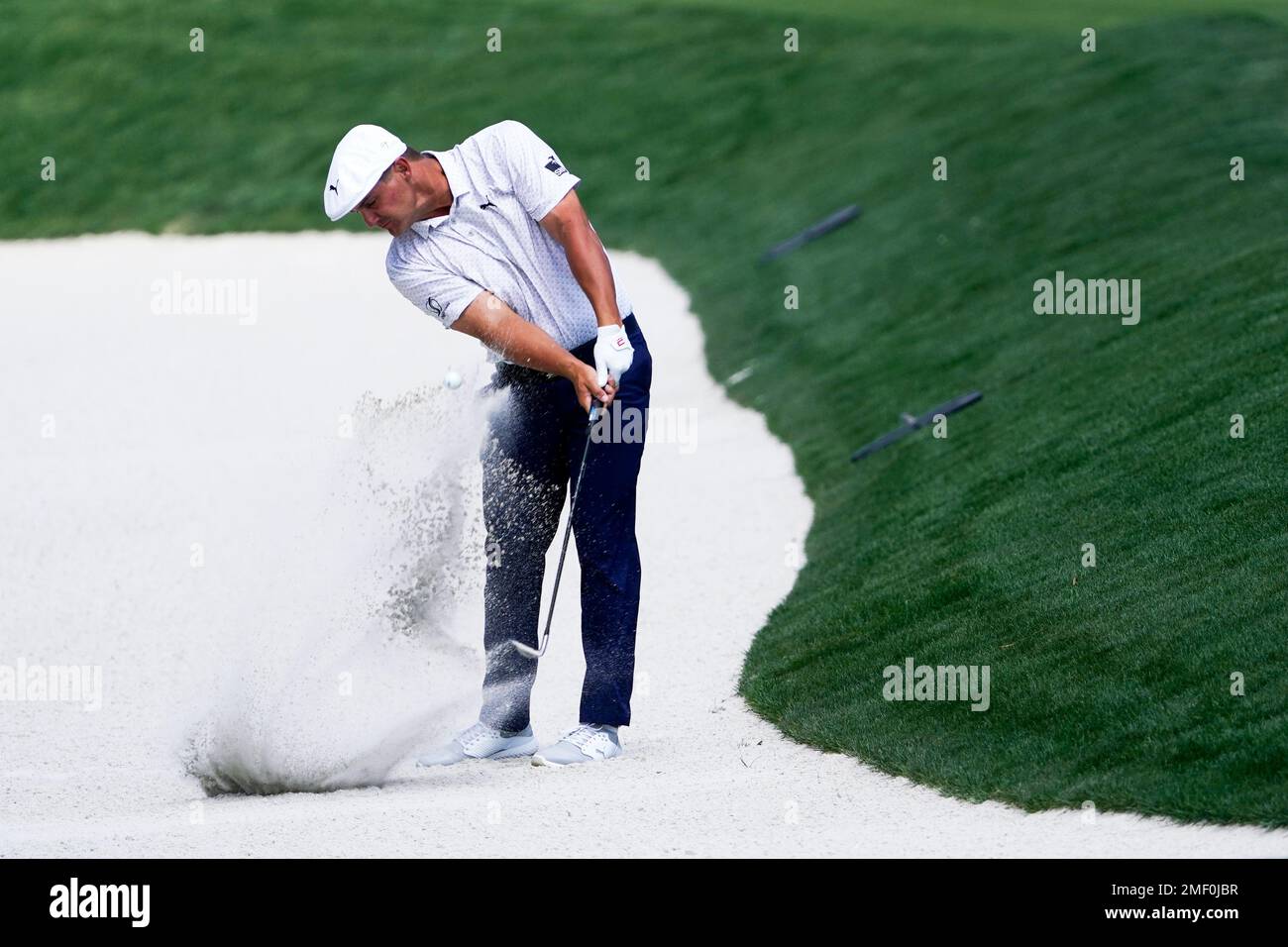 Bryson DeChambeau hits from the bunker on the second hole during the ...