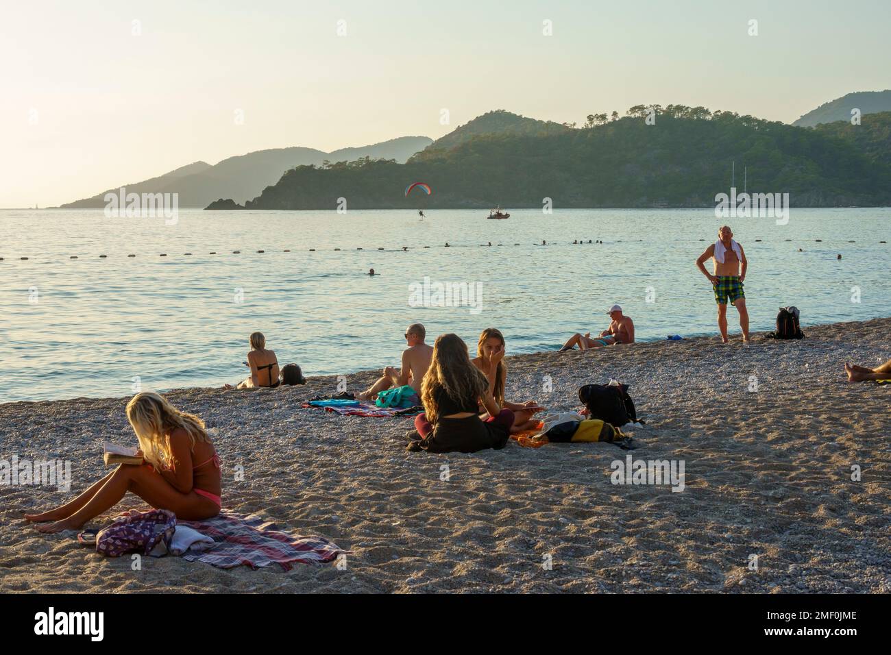 Beachgoers and paramotor in Belcekiz Beach, Oludeniz, Fethiye, Turkey ...