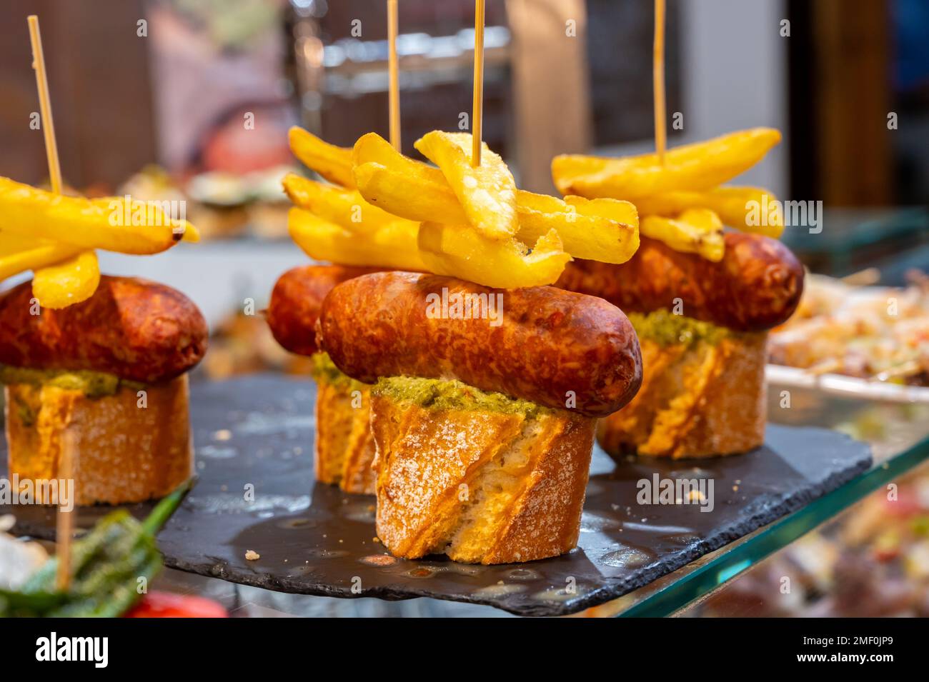 Typical snack of Basque Country, pinchos or pinxtos skewers with small ...