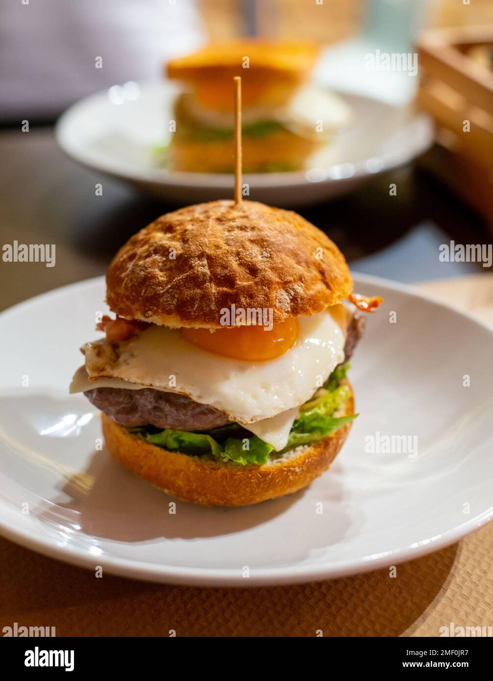 Tasty burger made with white crispy ban, beef burger, egg, green ...