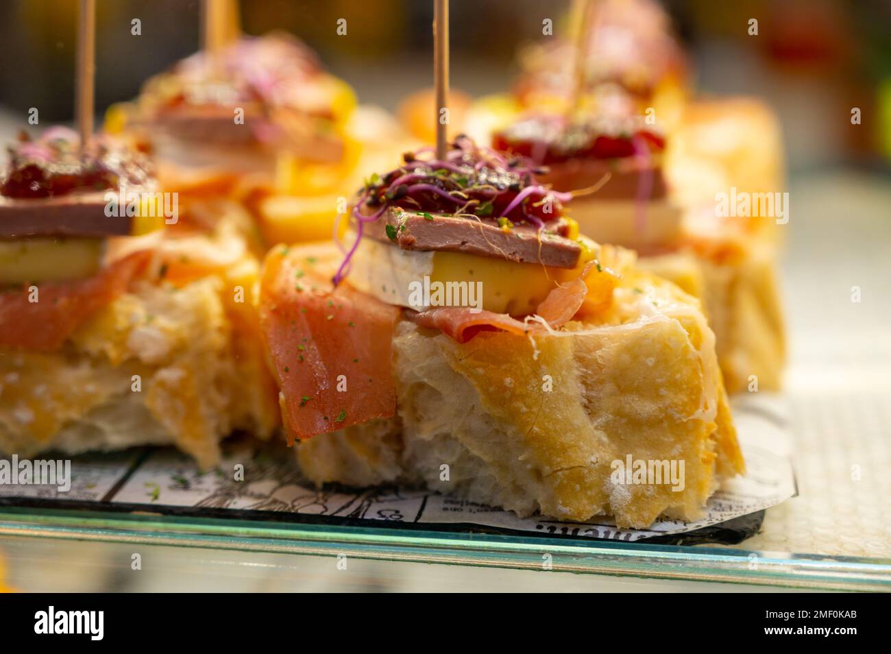Typical snack of Basque Country, pinchos or pinxtos skewers with small ...