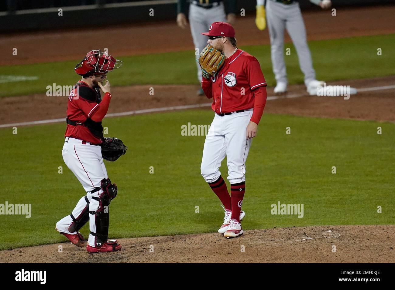 Cincinnati Reds relief pitcher Sean Doolittle, right, talks with Reds ...
