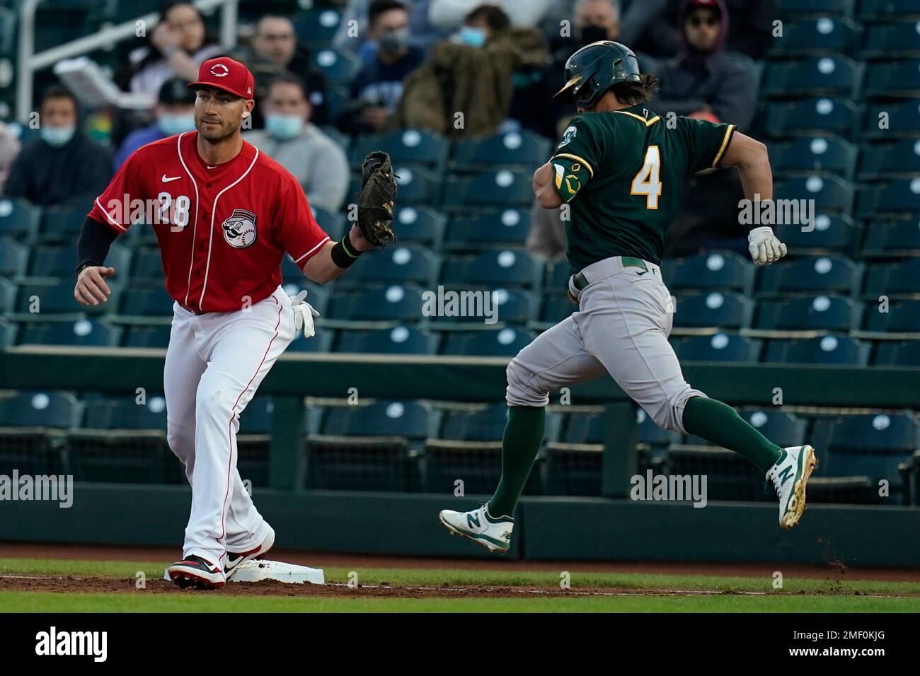 Cincinnati Reds first baseman Nicky Delmonico (28) makes a catch at ...