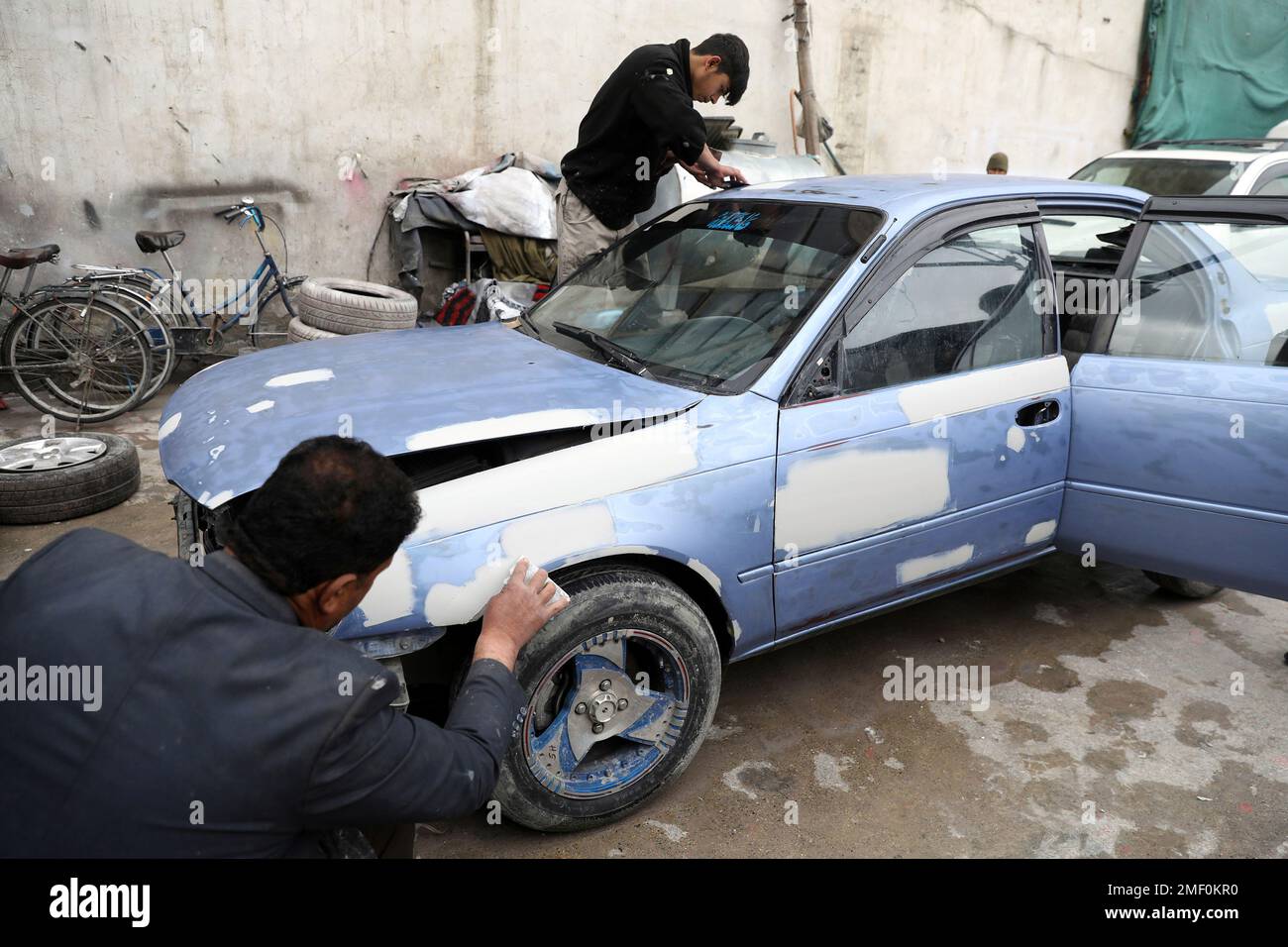 Car mechanic painters work at their paint chamber in Kabul, Afghanistan ...