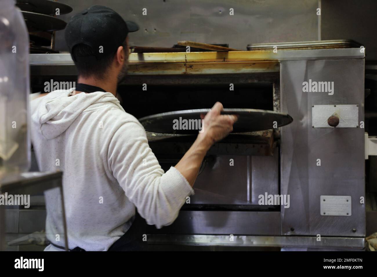 A view of the man making pizza in front of the oven Stock Photo - Alamy