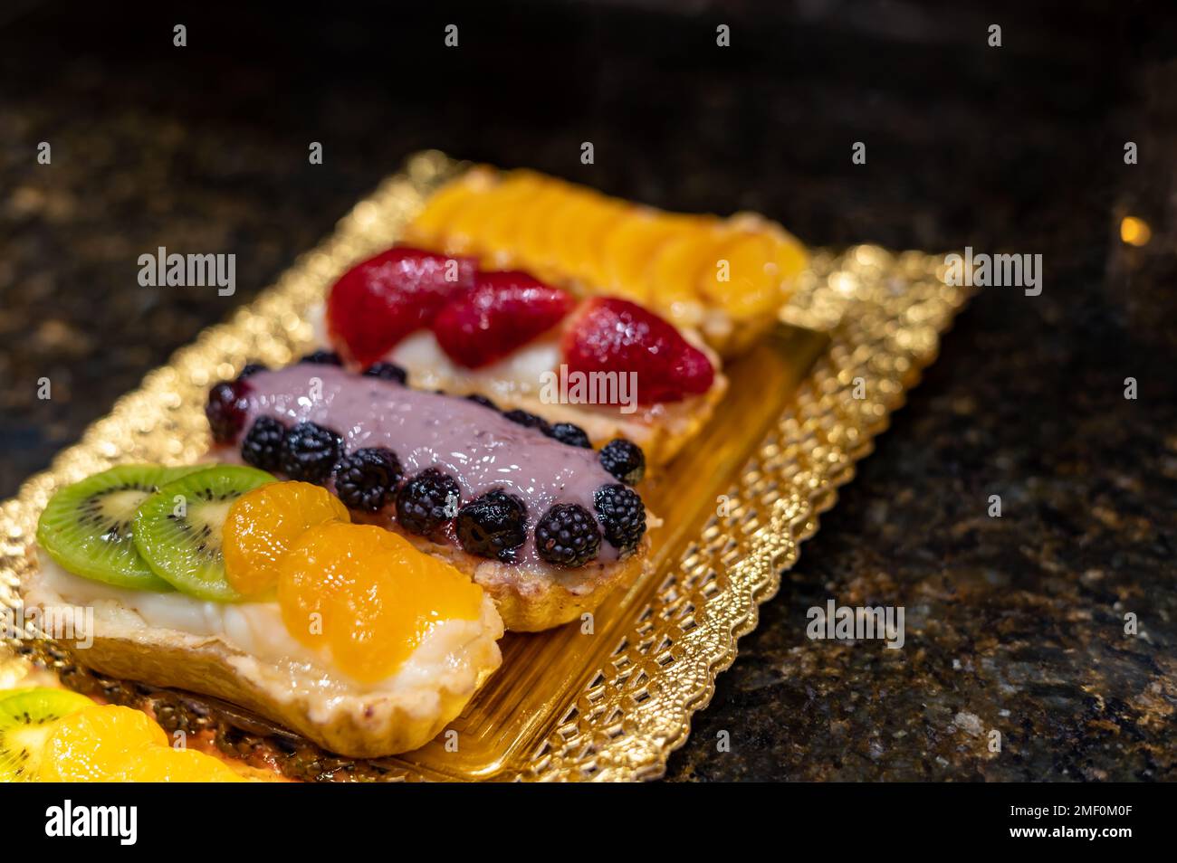 Delicious fresh baked colorful decorated cakes, tarts with cream and ...