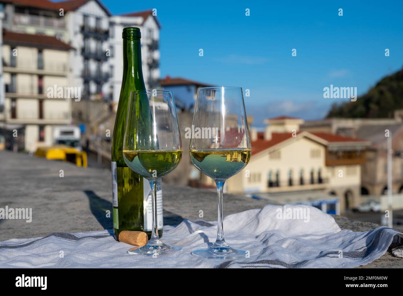 Tasting of txakoli or chacolí slightly sparkling very dry white wine ...
