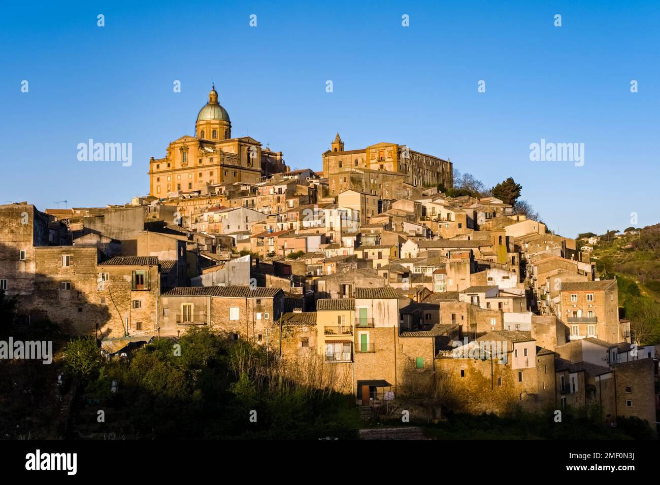 The houses of town, situated close together on a hill, the church ...