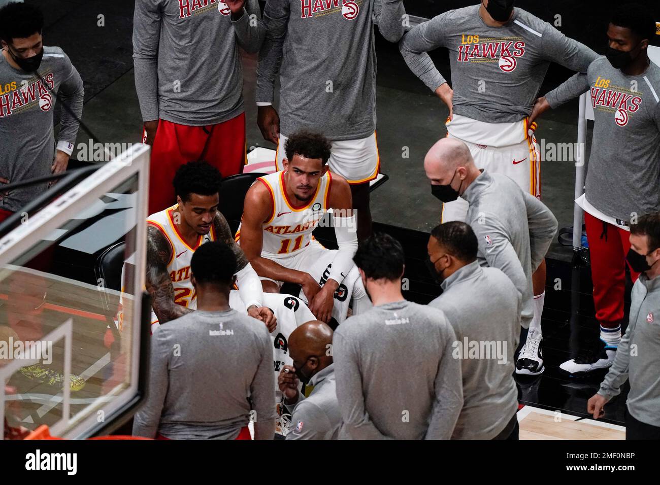 Atlanta Hawks' Trae Young, center, gathers in a team huddle during the ...
