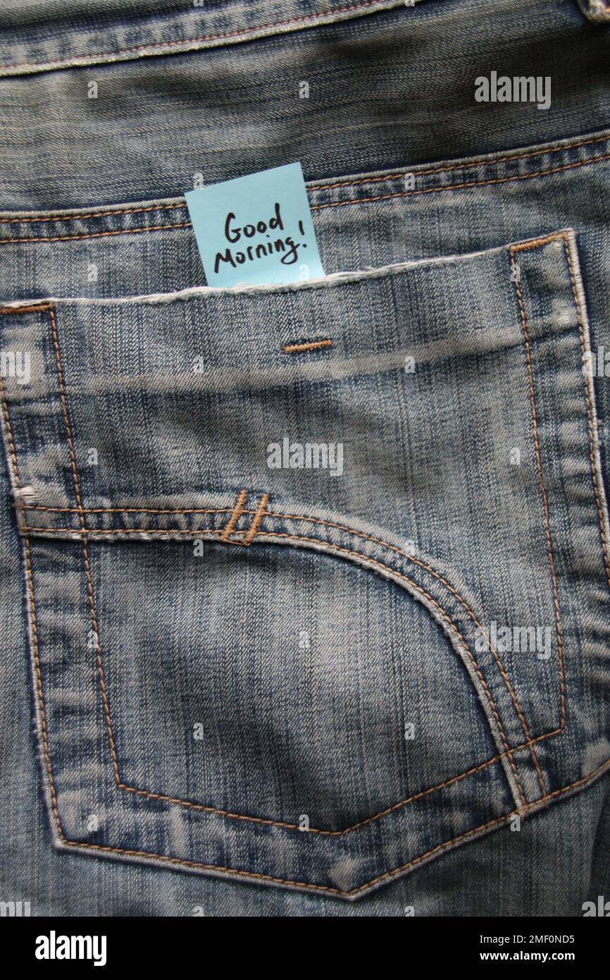 Good morning concept inscription on a tag in a pocket of blue jeans ...