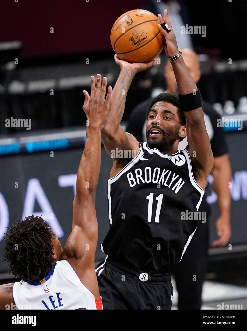 Brooklyn Nets guard Kyrie Irving (11) shoots over Detroit Pistons guard ...