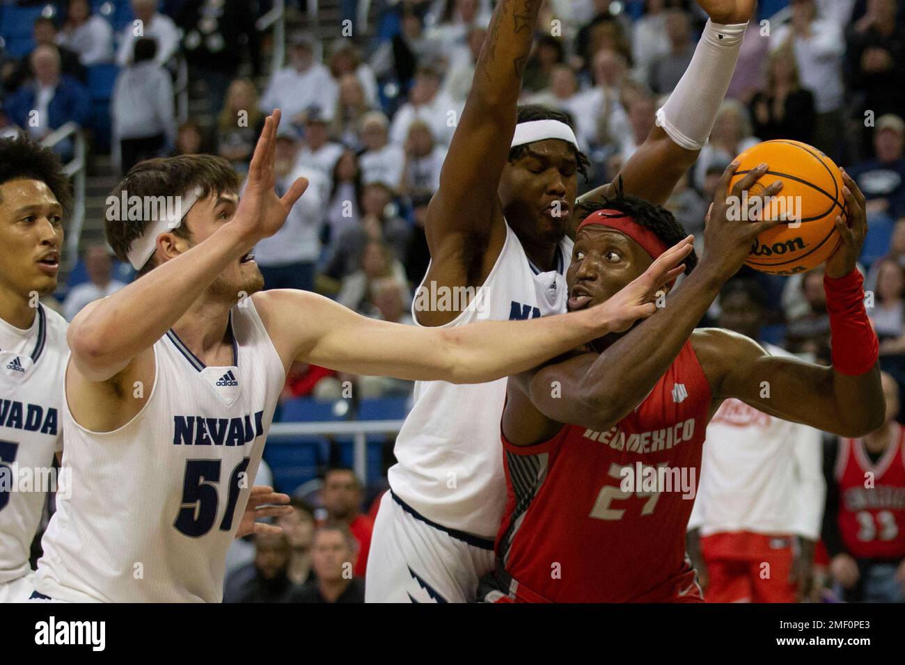 New Mexico forward Morris Udeze (24) is guarded by Nevada center Will ...
