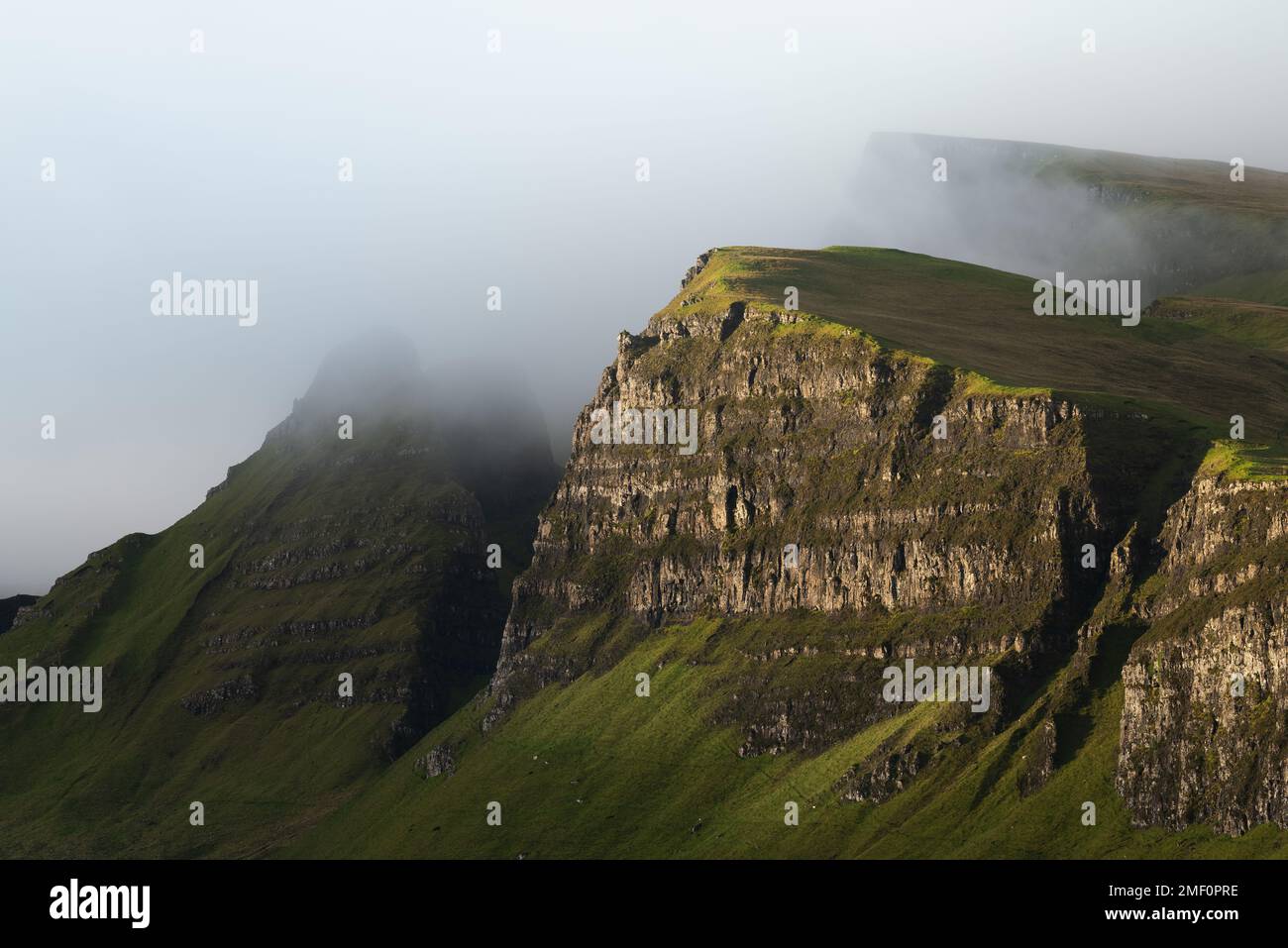 Dramatic cliffs of The Quraing, covered in low cloud. Isle of Skye ...