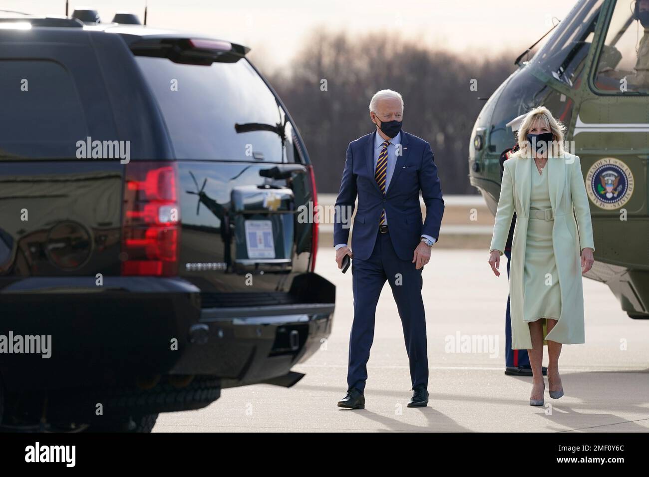 President Joe Biden and first lady Jill Biden walk to a motorcade ...