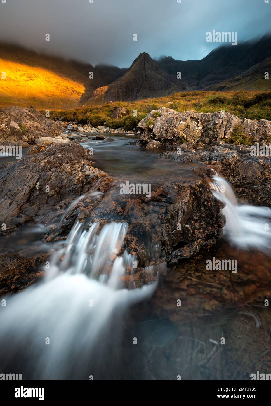 Fairy Pools Waterfall with view of famous Cuillin mountain range. Isle ...