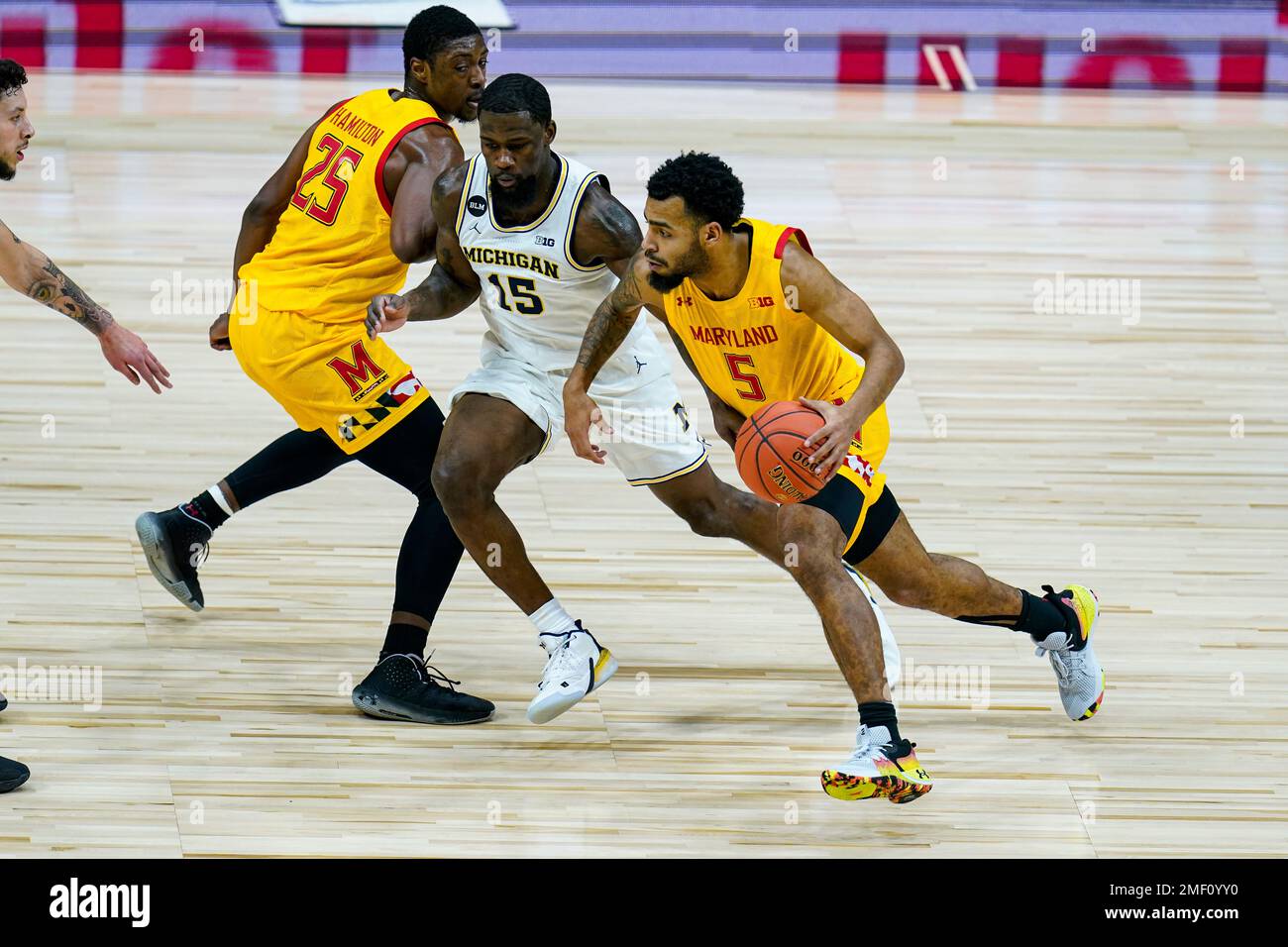 Maryland guard Eric Ayala (5) drive son Michigan guard Chaundee Brown ...
