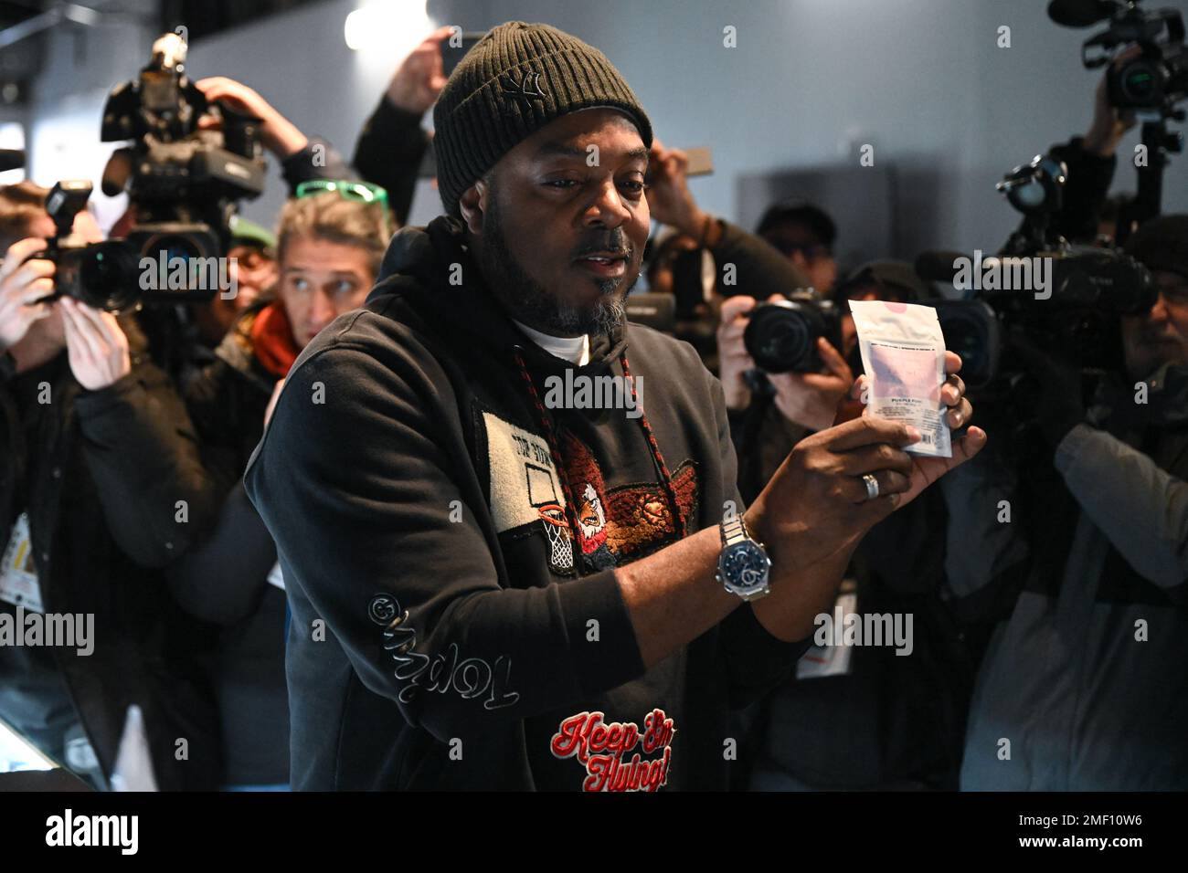 Owner Roland Conner (r) makes the first marijuana purchase from his son ...
