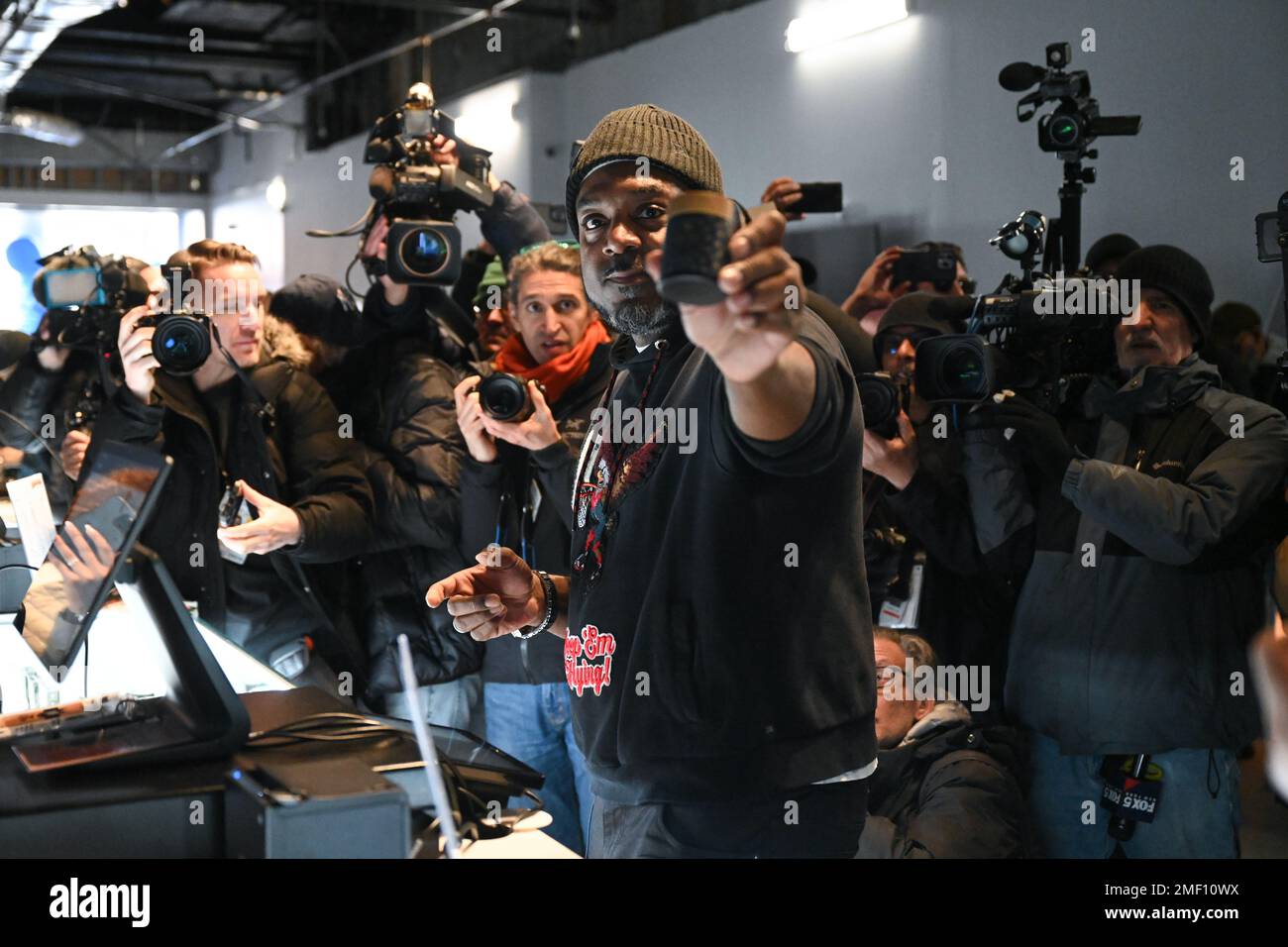 Owner Roland Conner (r) makes the first marijuana purchase from his son ...
