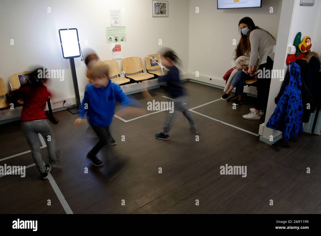 Nurse Sarah Merlin looks at children in the pediatric unit of the ...